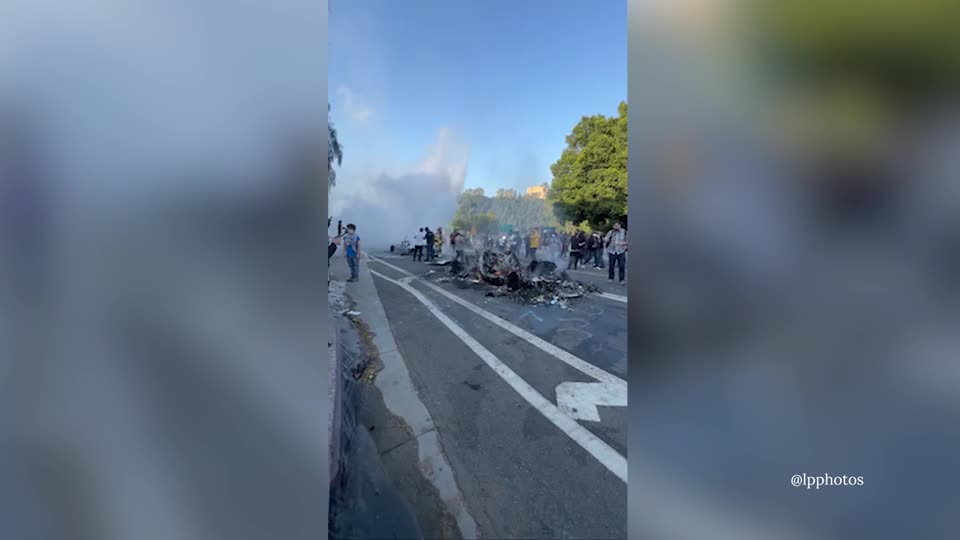 A Waymo robotaxi was vandalized and burned during a protest in Los ...